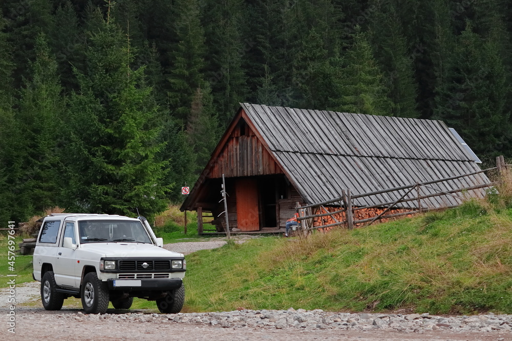 Auto 4x4 terenowe w górach, w tle górski domek drewniany. Polskie Tatry ...