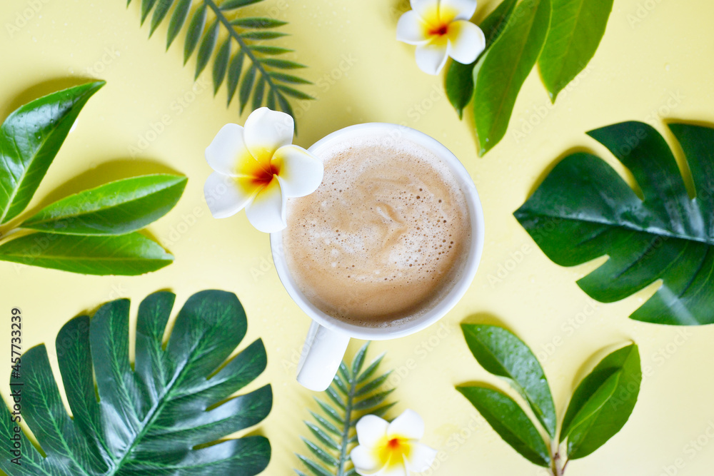 Cup of coffee with tropical leaves on the yellow background. Coffee ...