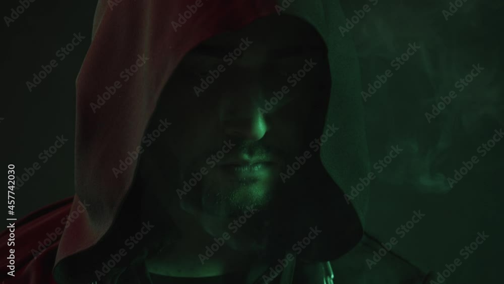 Evil exorcist wearing black suit on dark background. Portrait of wicked ...