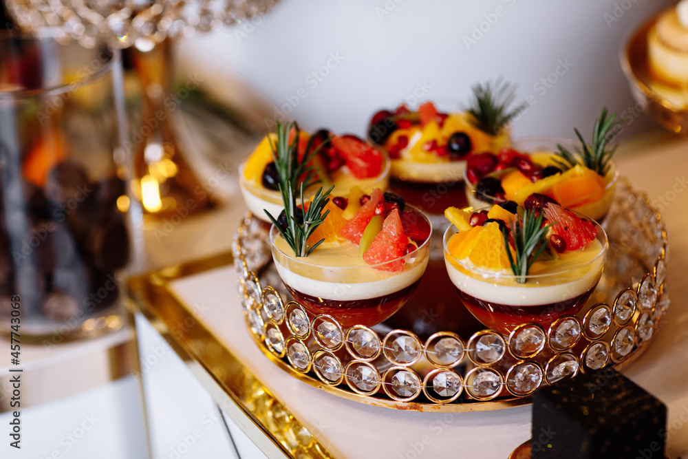 luxury wedding catering, table with modern desserts, cupcakes, sweets ...