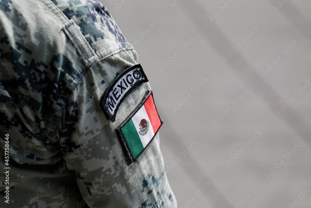 The Mexican flag is seen on the uniform of an army soldier during a ...