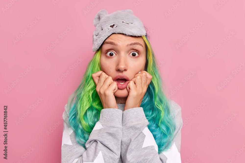 Startled young millennial woman with long dyed hair stares bugged eyes ...