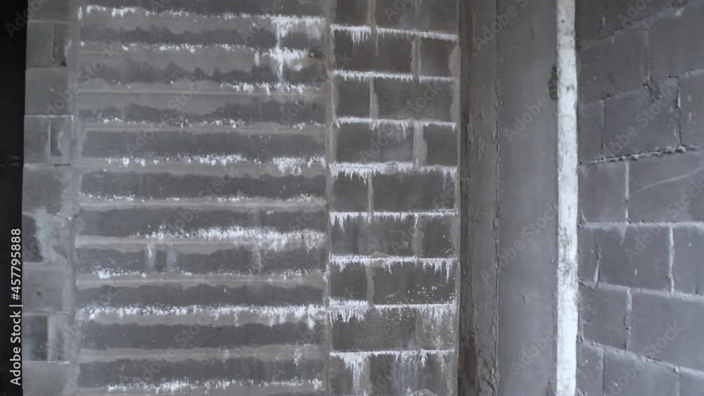 Unpainted concrete block wall in a new home. The interior of the ...