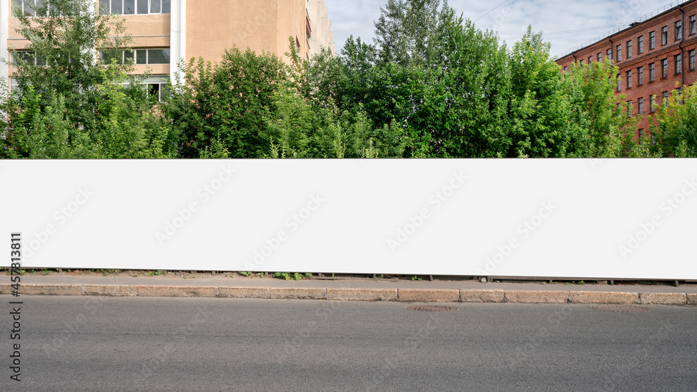 Long huge hoarding with empty space for mockup on street pavement ...