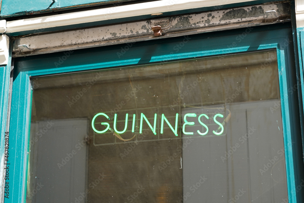 guinness beer sign text and brand logo front of windows building of ...