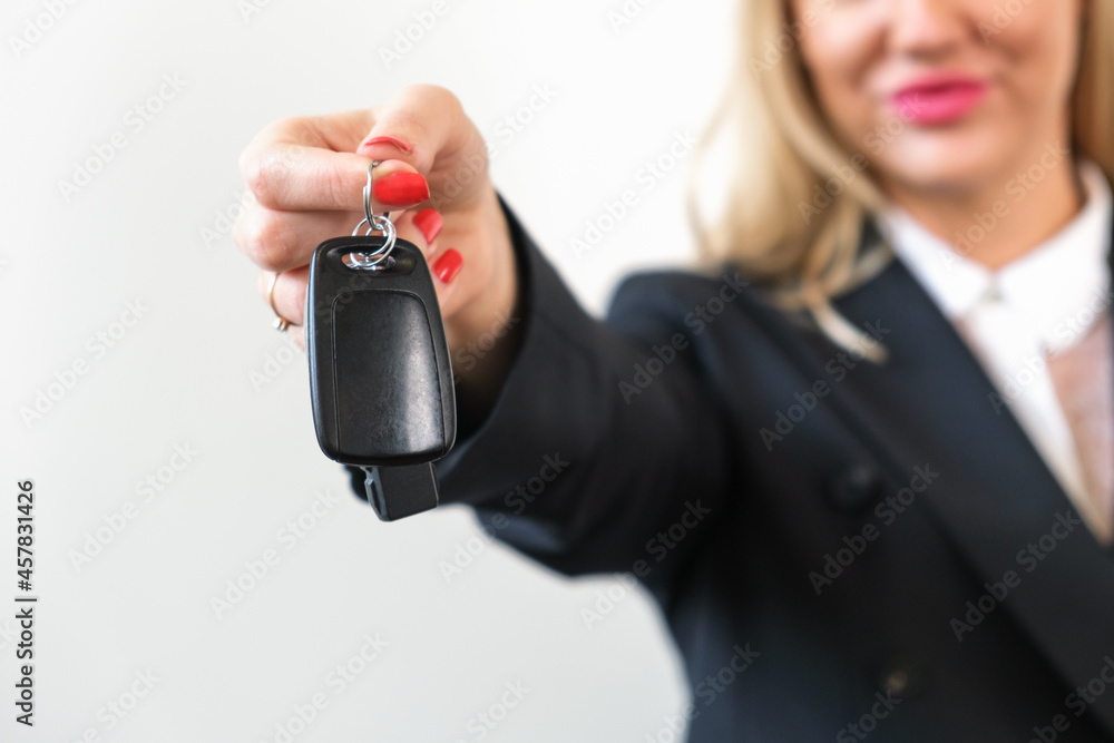 Employee of a car sales company hand over car key to client. Close-up ...