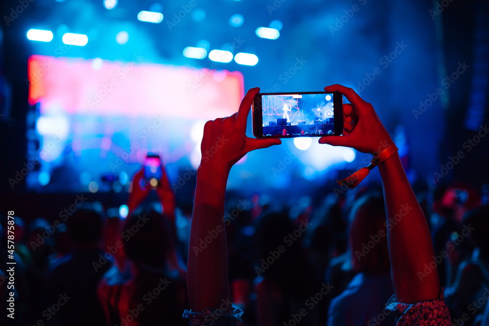 Hand with a smartphone records live music festival, Taking photo of ...