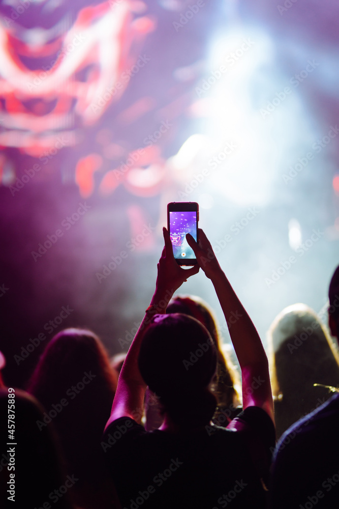 Hand with a smartphone records live music festival, Taking photo of ...