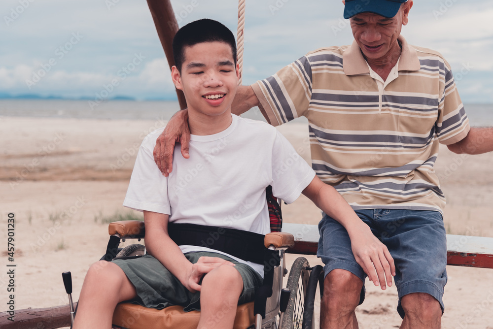 Happy disabled teenager boy smiling face with parent on outdoors ...