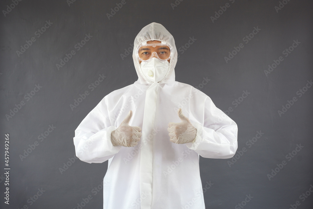 Asian man wearing PPE suit giving thumbs up with both hands Stock Photo ...