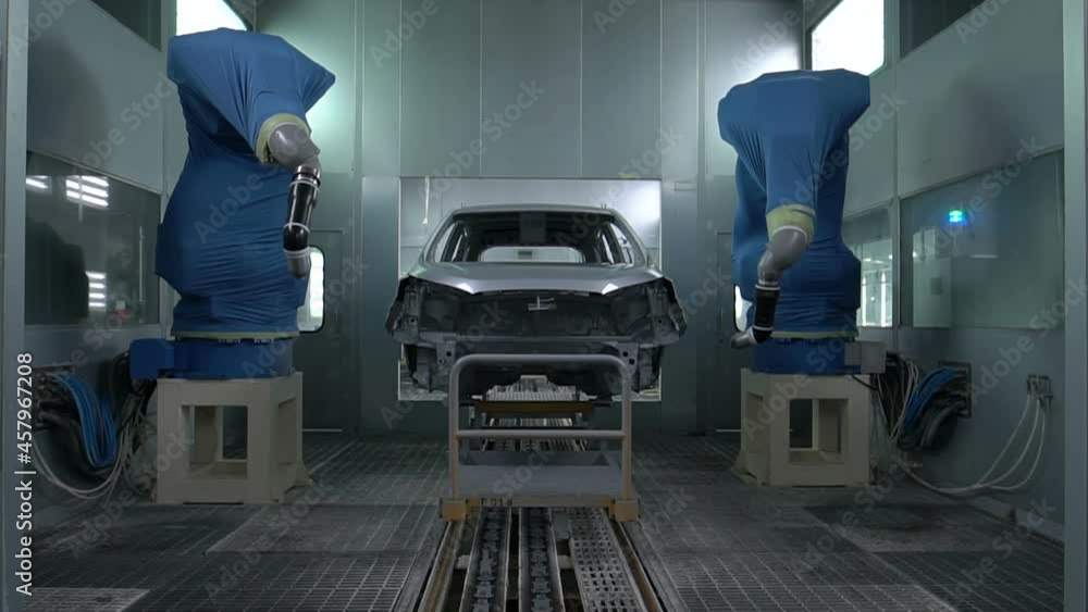 Industrial spray painting process. Auto robot painter sprays white ...