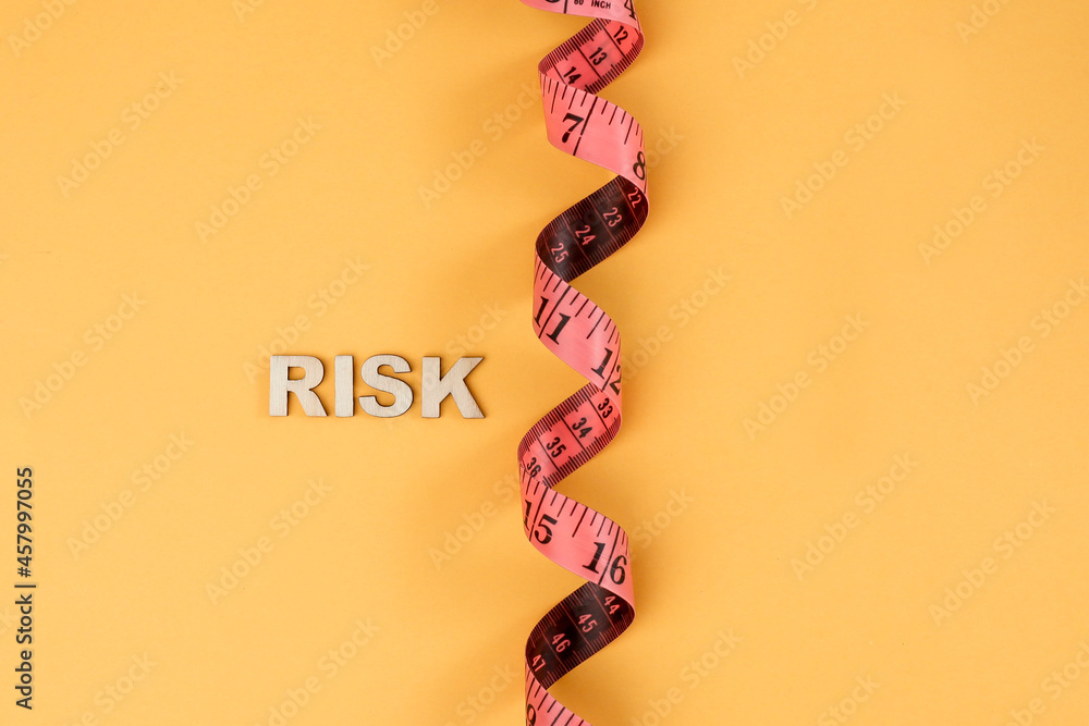 RISK letterings on the yellow background with a measuring tape Stock ...