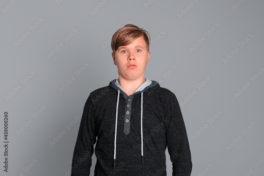 Portrait of funny astonished, shocked boy. Teen boy opening his mouth ...