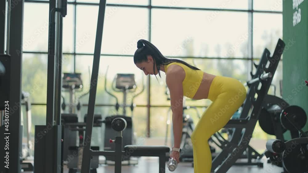 Hispanic woman performing barbell bent over row. Fitness woman training ...
