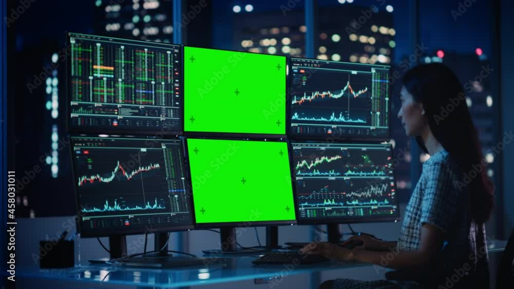 Financial Analyst Working on Computer with Multi-Monitor Workstation ...