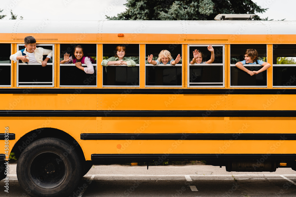 Front view of schoolchildren classmates pupils looking out of the ...