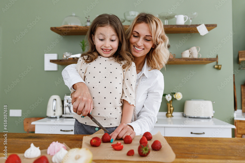 Happy scared chef baker mom woman in white shirt work with child baby ...