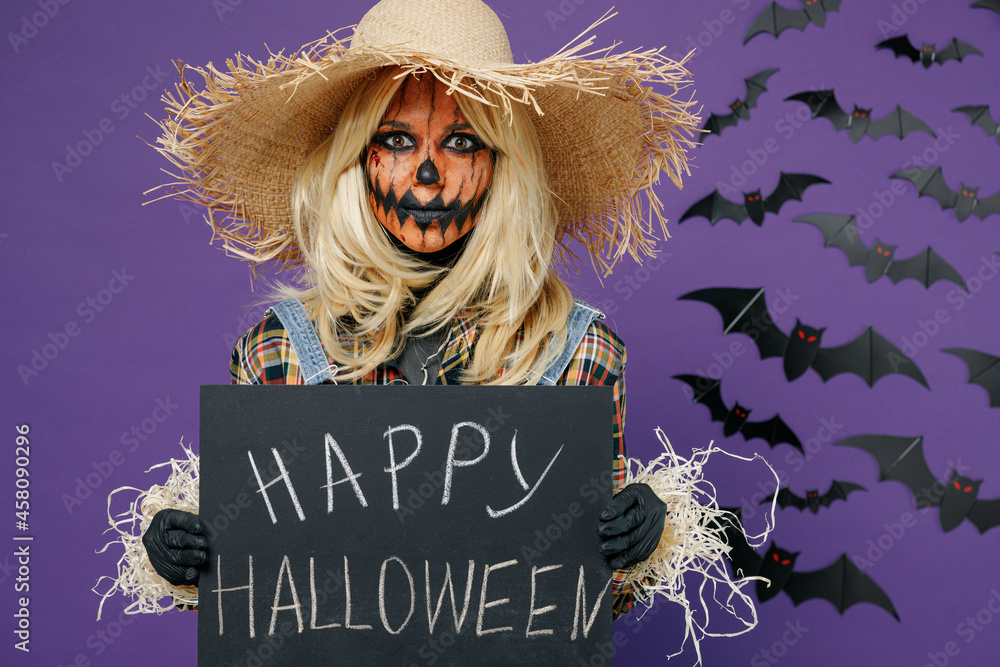 Young serious woman 20swith makeup mask in straw hat scarecrow costume ...