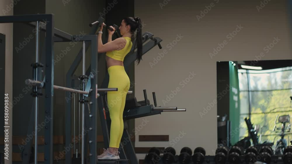 Hispanic Woman Does Pull-Ups On Gravitron For Strengthening The ...