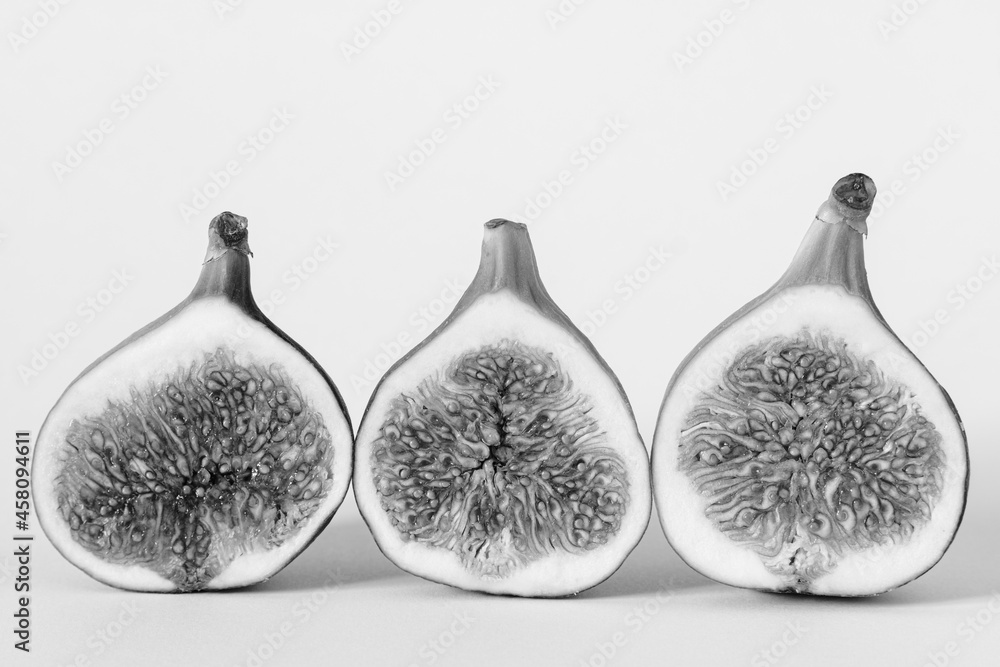 Black and white photo of halved figs. Three figs side by side. Culinary ...