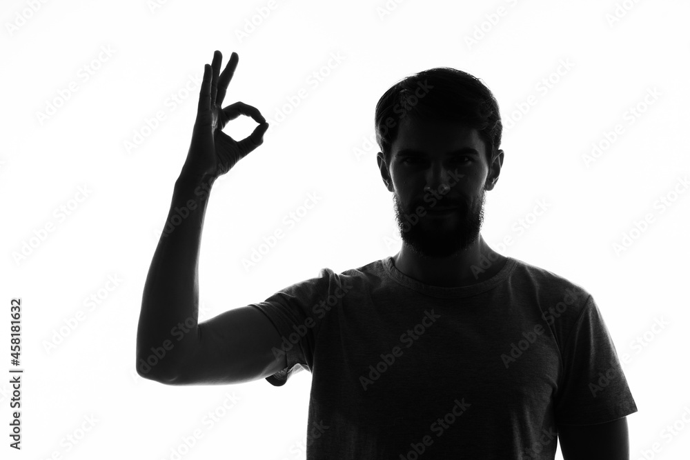 The man in a suit with a pistol in hand crime hand gesture posing ...