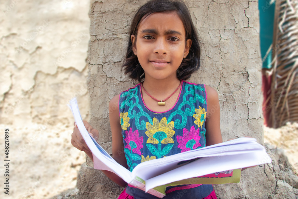 Indian rural girl reading book at home Stock Photo | Adobe Stock