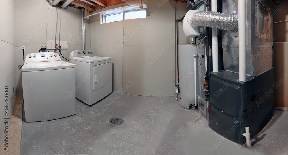 A home laundry room with a dryer, washer, a high efficiency furnace ...