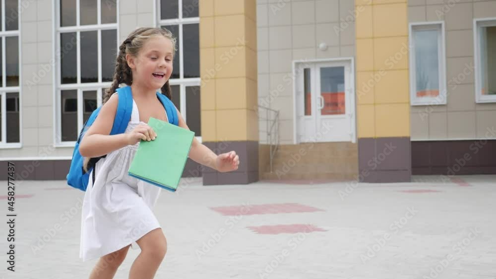 little girl kid with backpack and a textbook fun runs in hurrying to ...