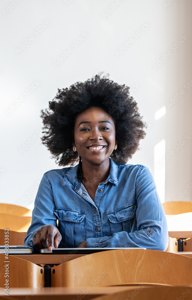 Young black female student sitting in collage classroom . Stock Photo ...