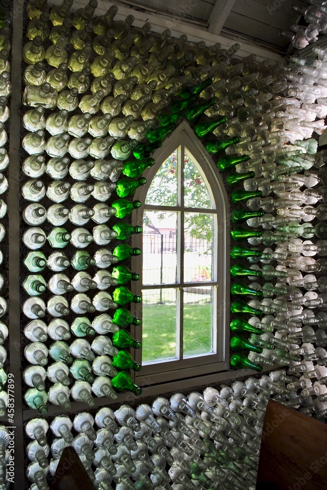 Treherne, Manitoba, Canada - 2016: Green and clear bottles make a wall ...