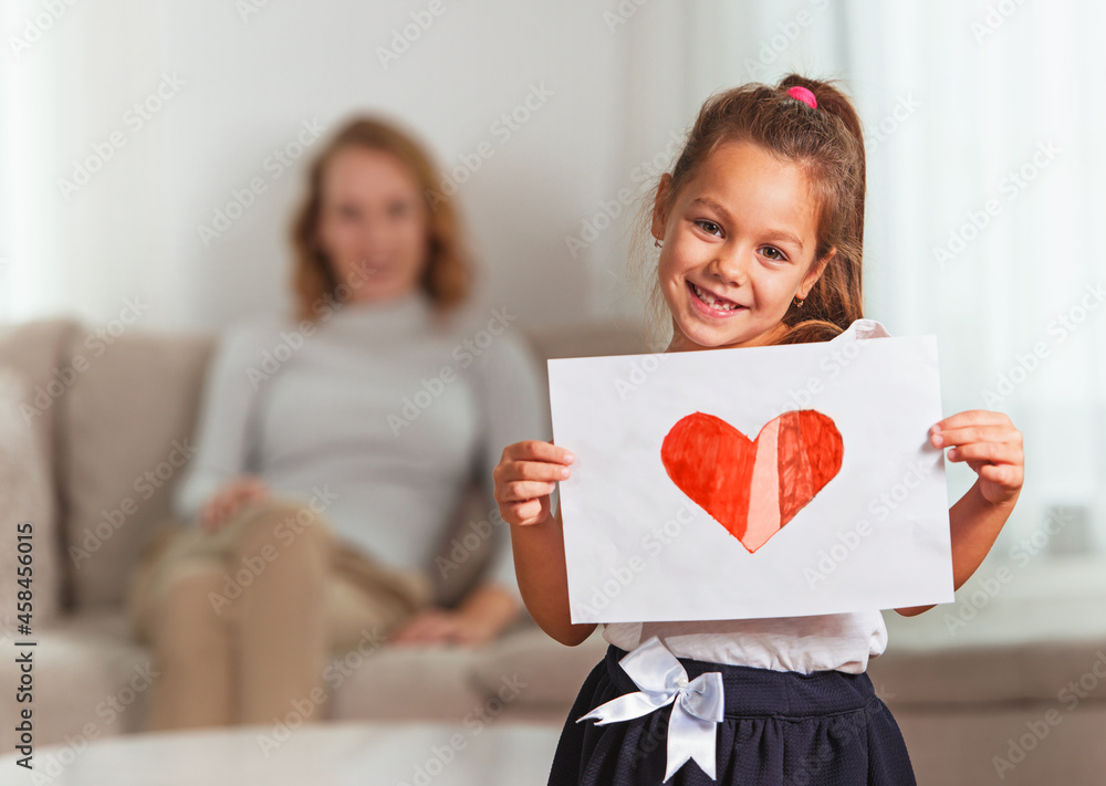 Cute little girl giving a heart-drawing to her mother Stock Photo ...