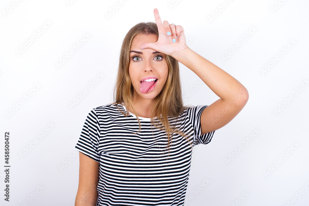 beautiful blonde girl wearing striped t-shirt on white background ...