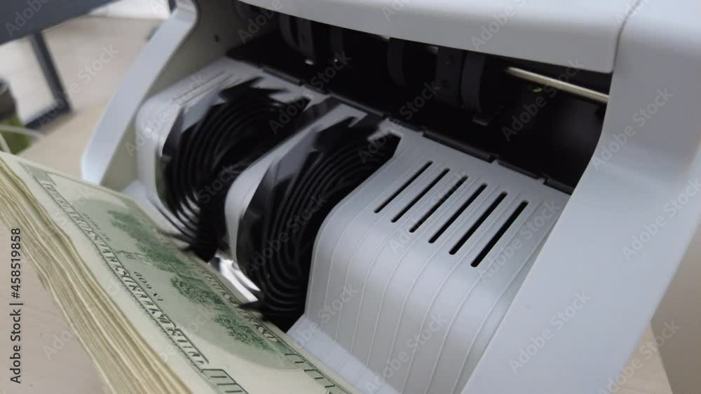 Counting machine for banknotes. Dollars in a calculating machine ...