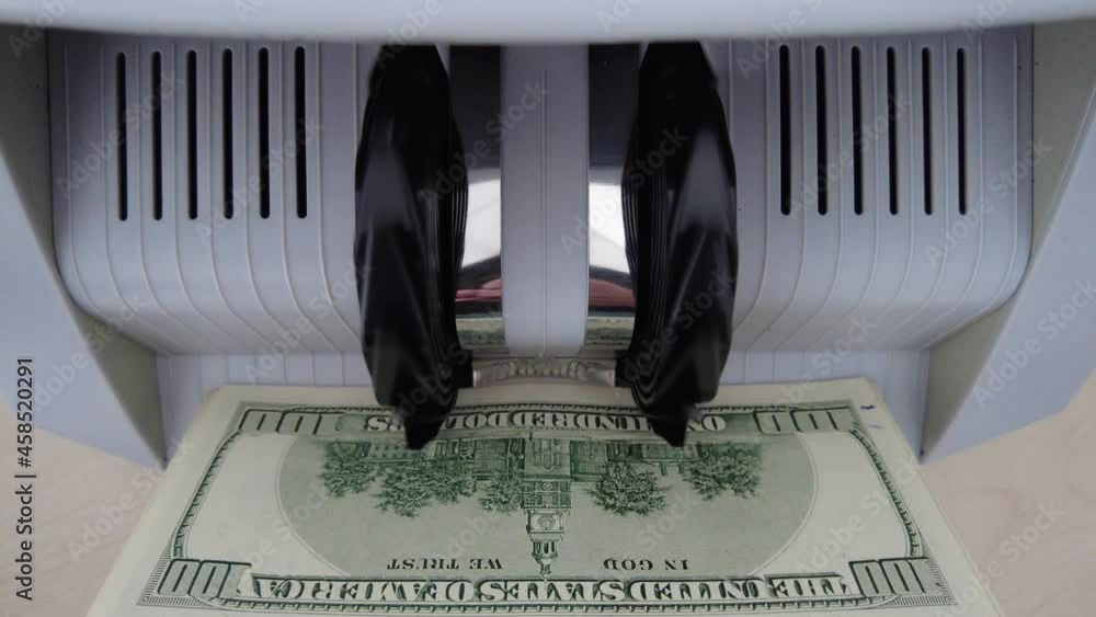 Counting machine for banknotes. Dollars in a calculating machine ...