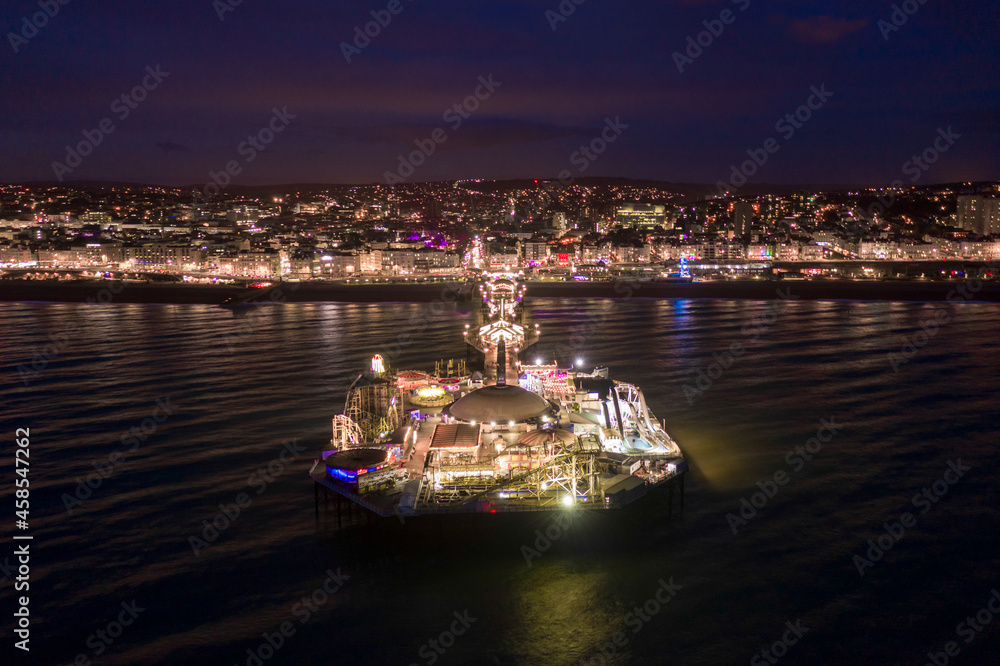 Brighton Seafront Palace Pier and Fun Fair Illuminated at Night Aerial ...