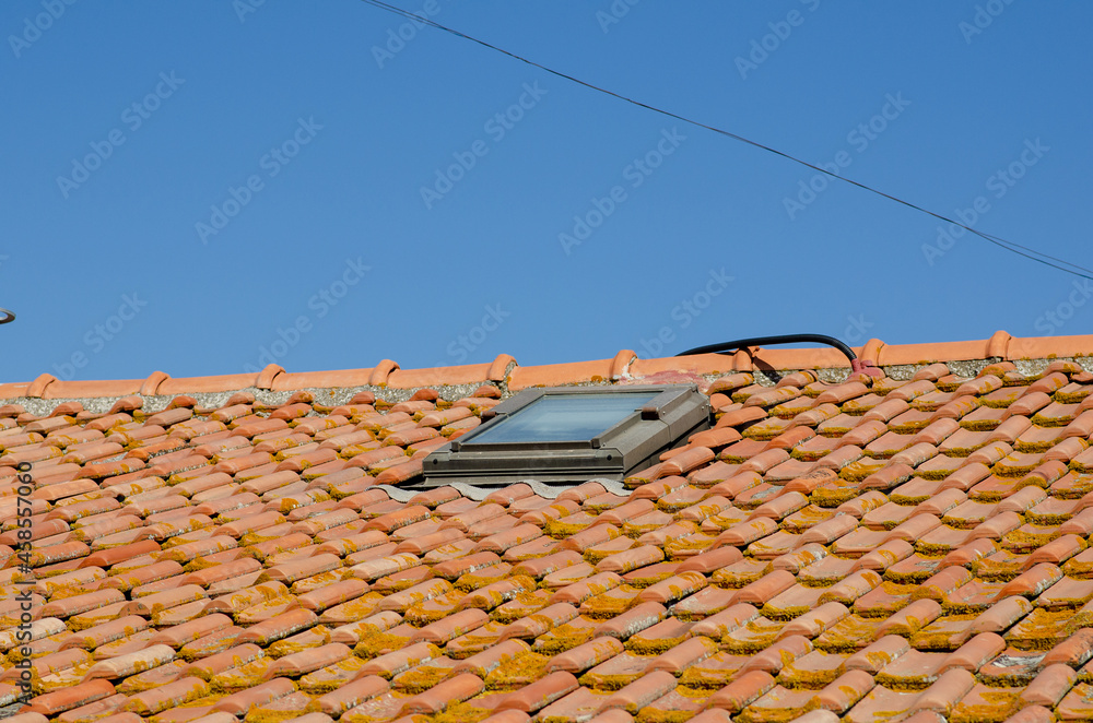 House: building with roof window made of brick tiles, visible the upper ...