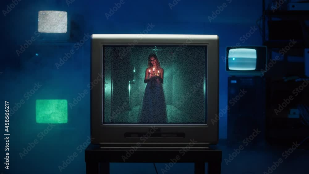 Old tv screen showing zombie woman holding burning candles close-up ...