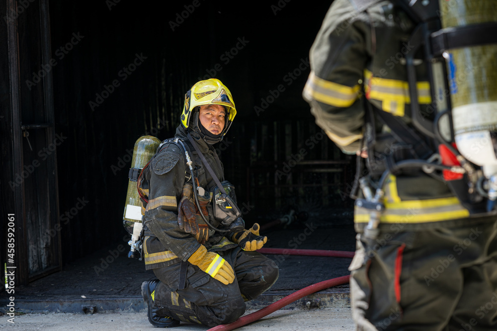 Fireman,Firefighters fighting a fire and spraying high pressure water ...