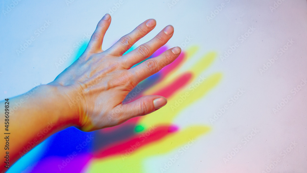 A blurred background with a shadow from the palm of the hand of yellow ...