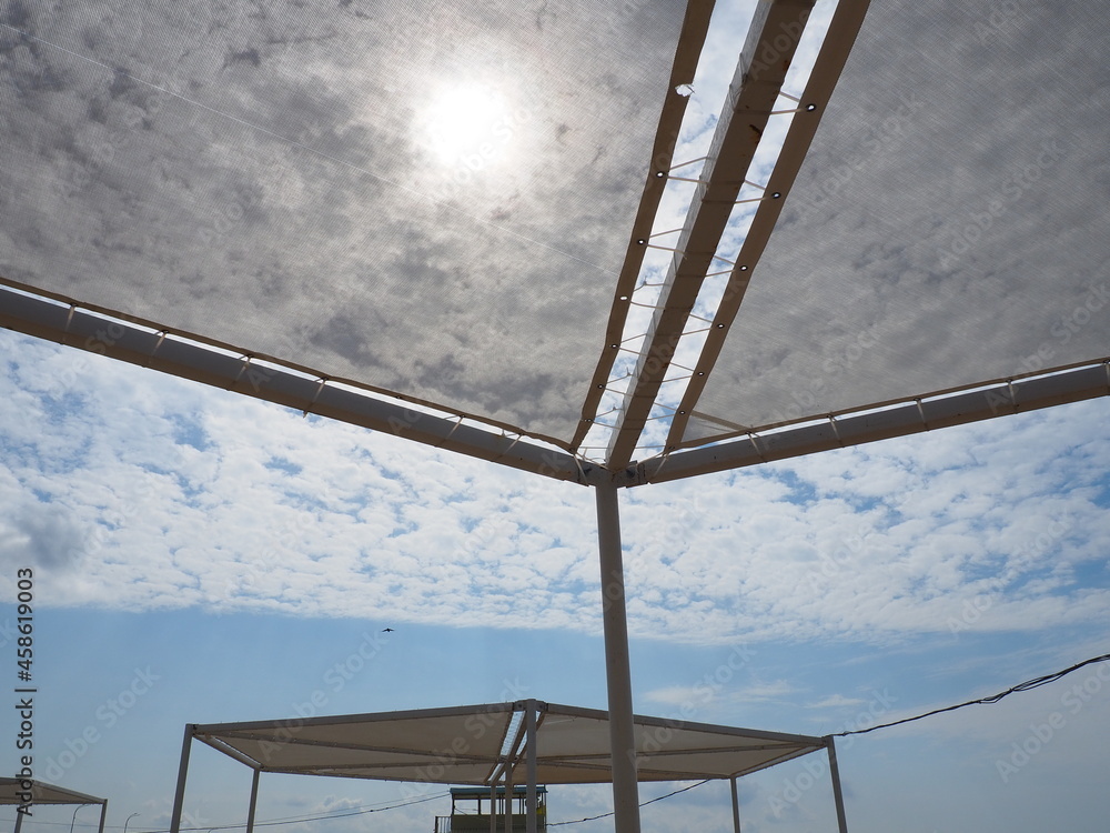 Shading canopy made of wooden beams and white fabric. Enjoy your time ...
