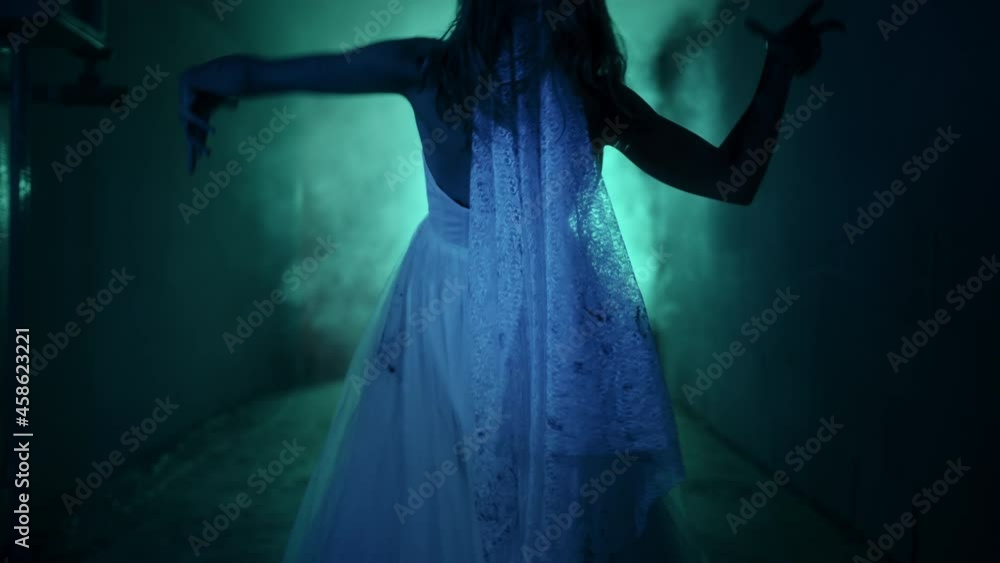 Dead zombie woman scaring in dark corridor close-up. Creepy bride ...