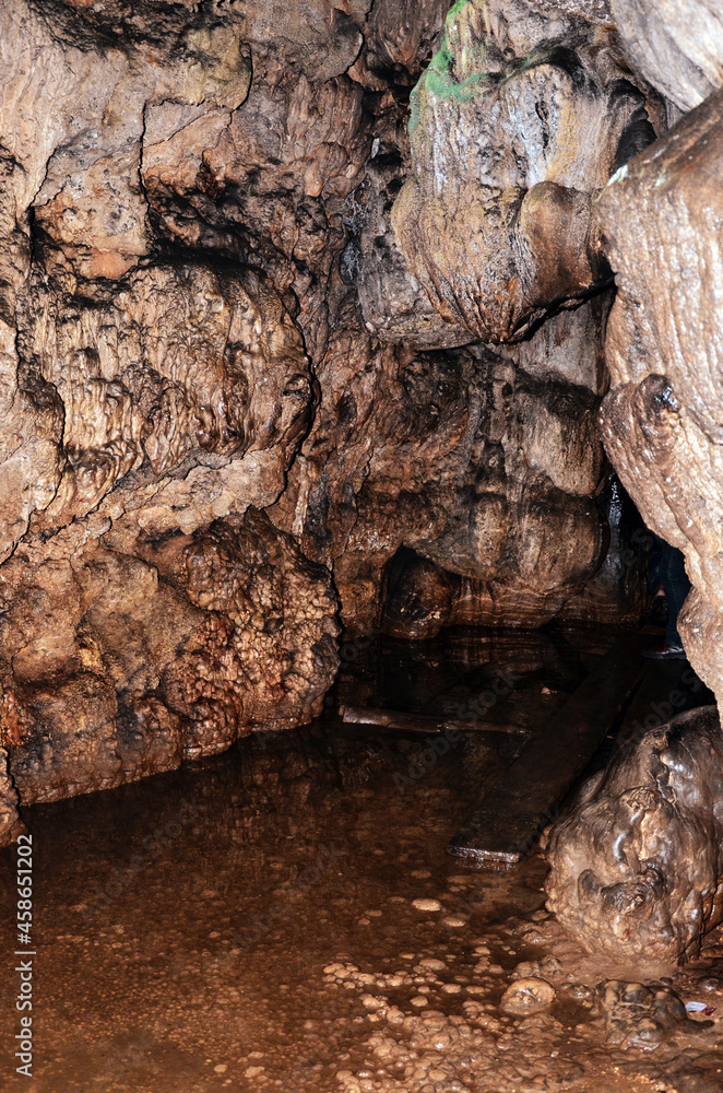 Entry path of a mysterious cave. Stone texture of a cave entrance gate ...