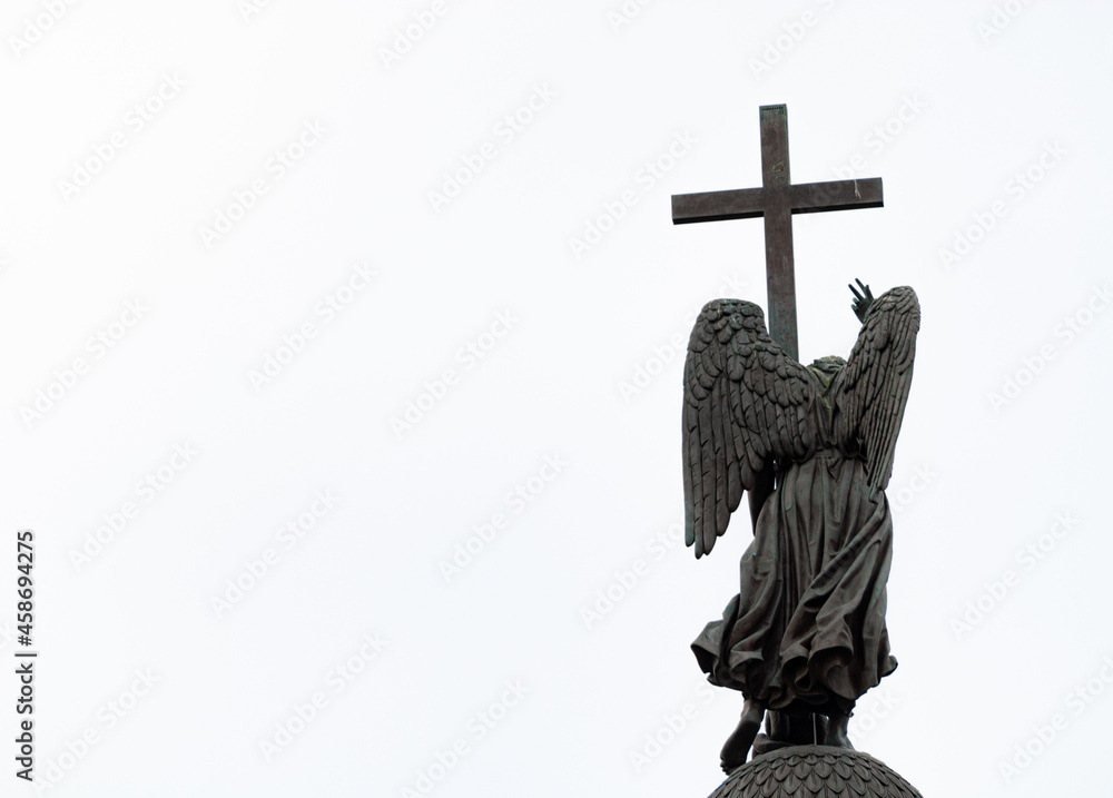 a winged guardian angel with a large cross on a white background stands ...
