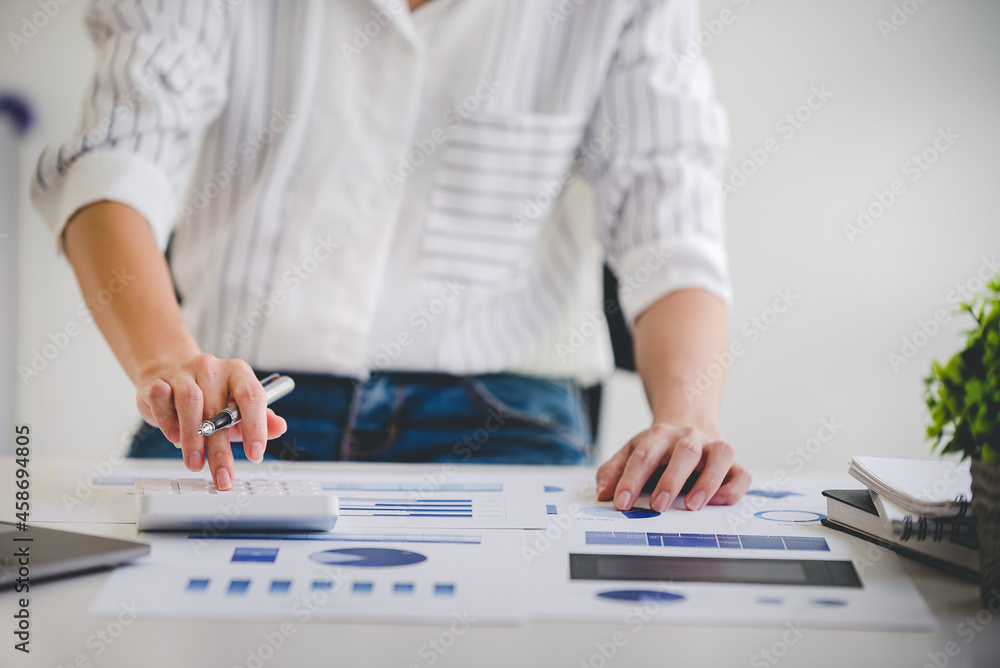 businessman or accountant who are using a calculator to calculate ...