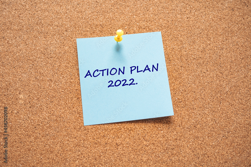 Blue paper note written with Action Plan 2022. on corkboard. Business ...