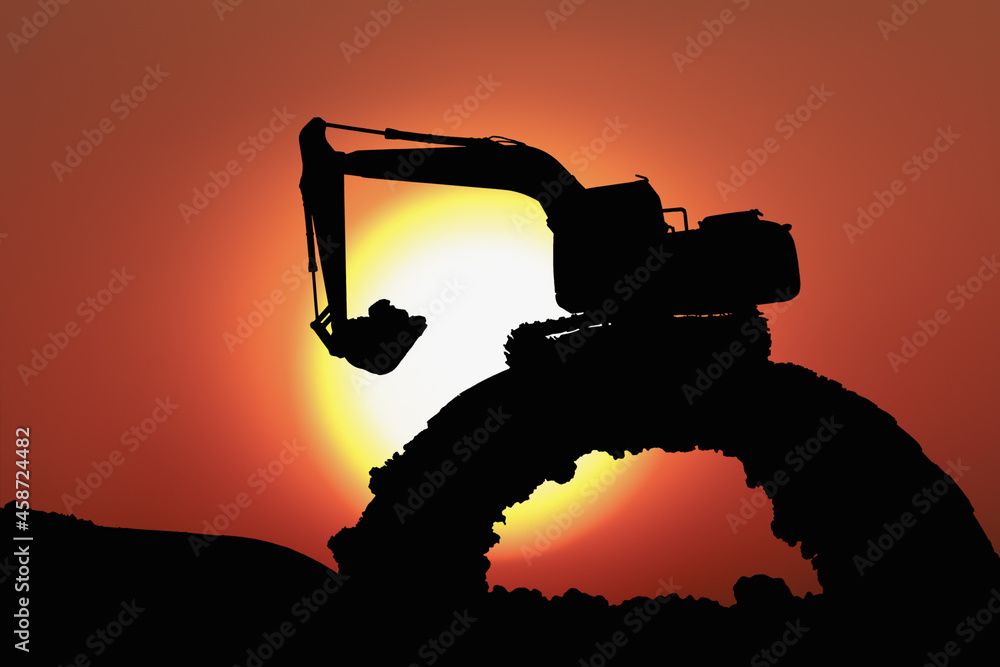 Excavators silhouette are digging the soil in the construction site ...