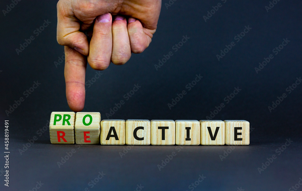 Reactive or proactive symbol. Businessman turns wooden cubes and ... Reactive or proactive symbol. Businessman turns wooden cubes and ...