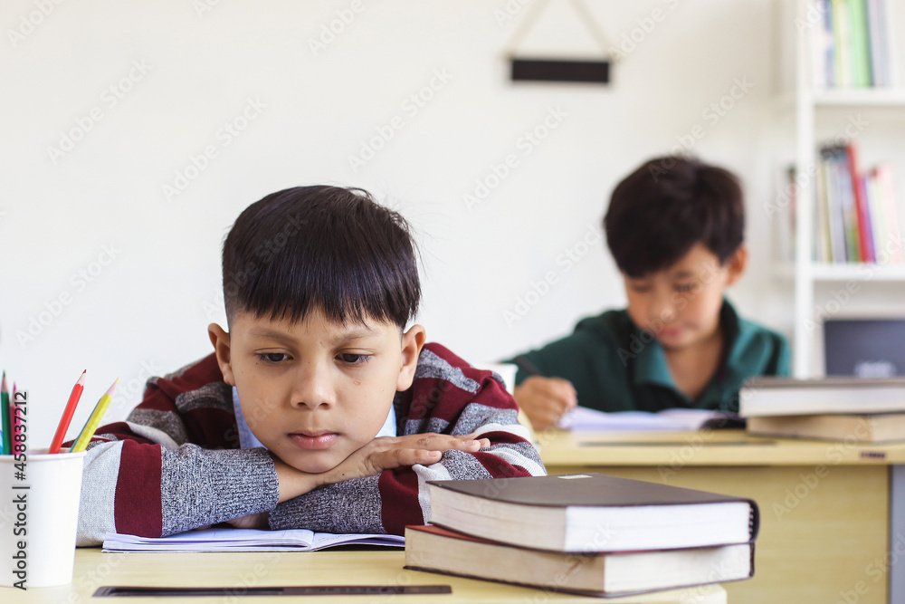 Asian student sitting daydreaming during a lesson in a classroom Stock ...