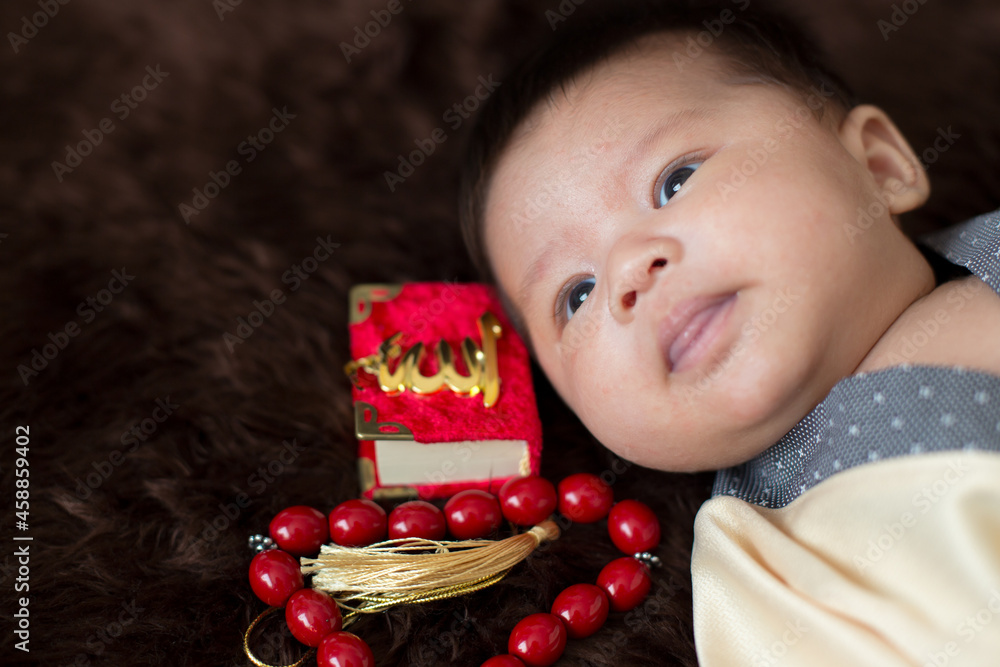 A cute Asian infant Muslim in thobe and rosary beads on red, muslim ...
