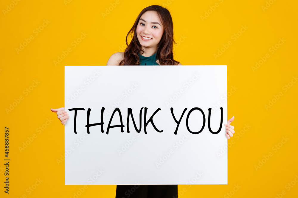 Young happy Asian women smiling and holding huge white cardboard sign ...